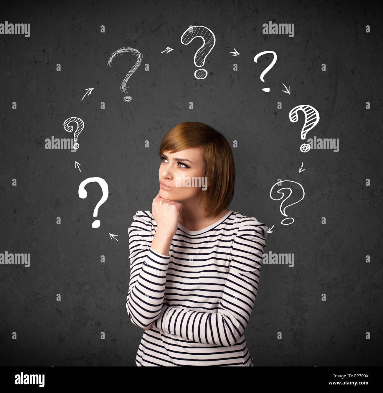 Young woman thinking with question mark circulation around her head ...