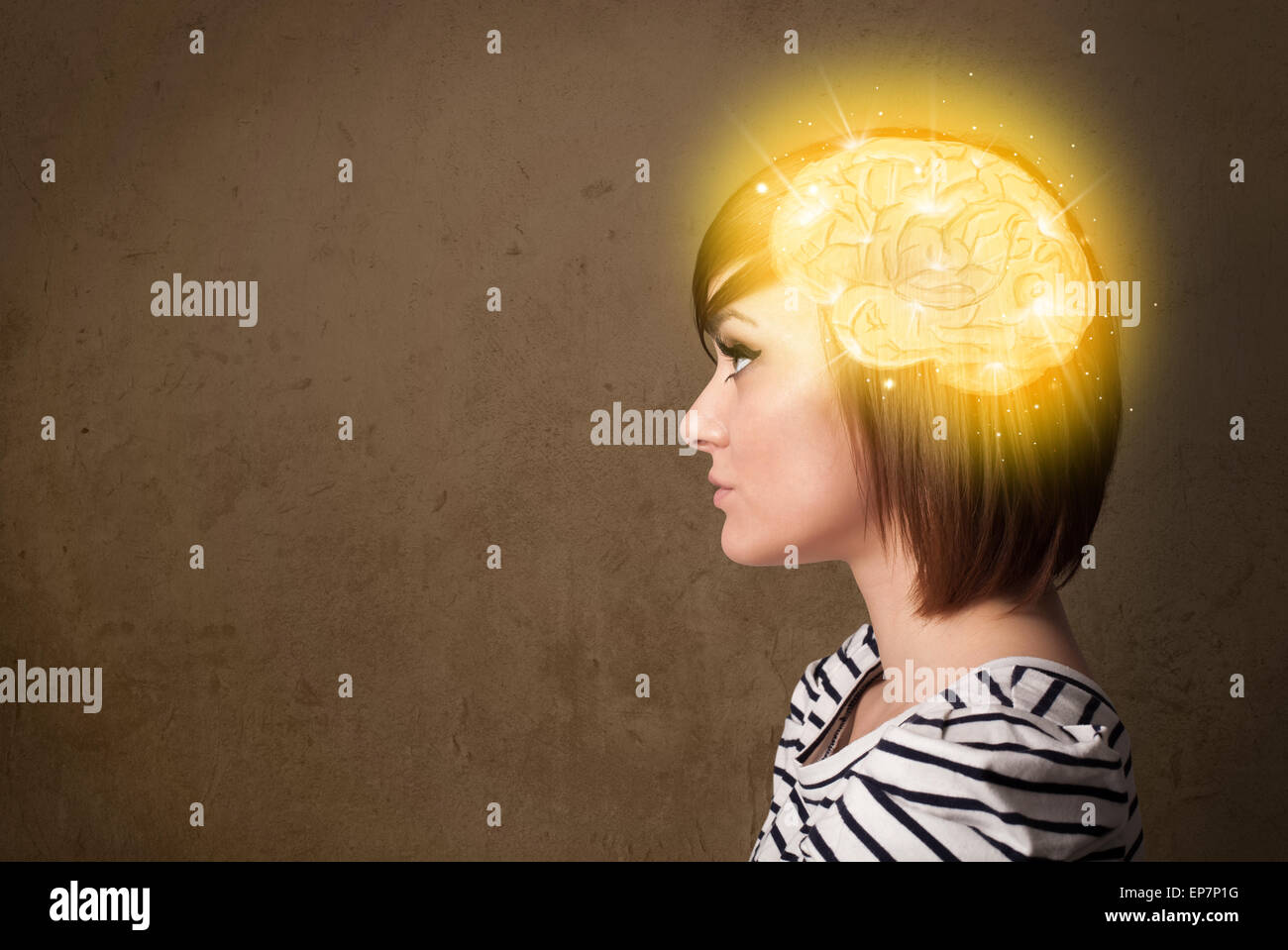 Young girl thinking with glowing brain illustration Stock Photo - Alamy
