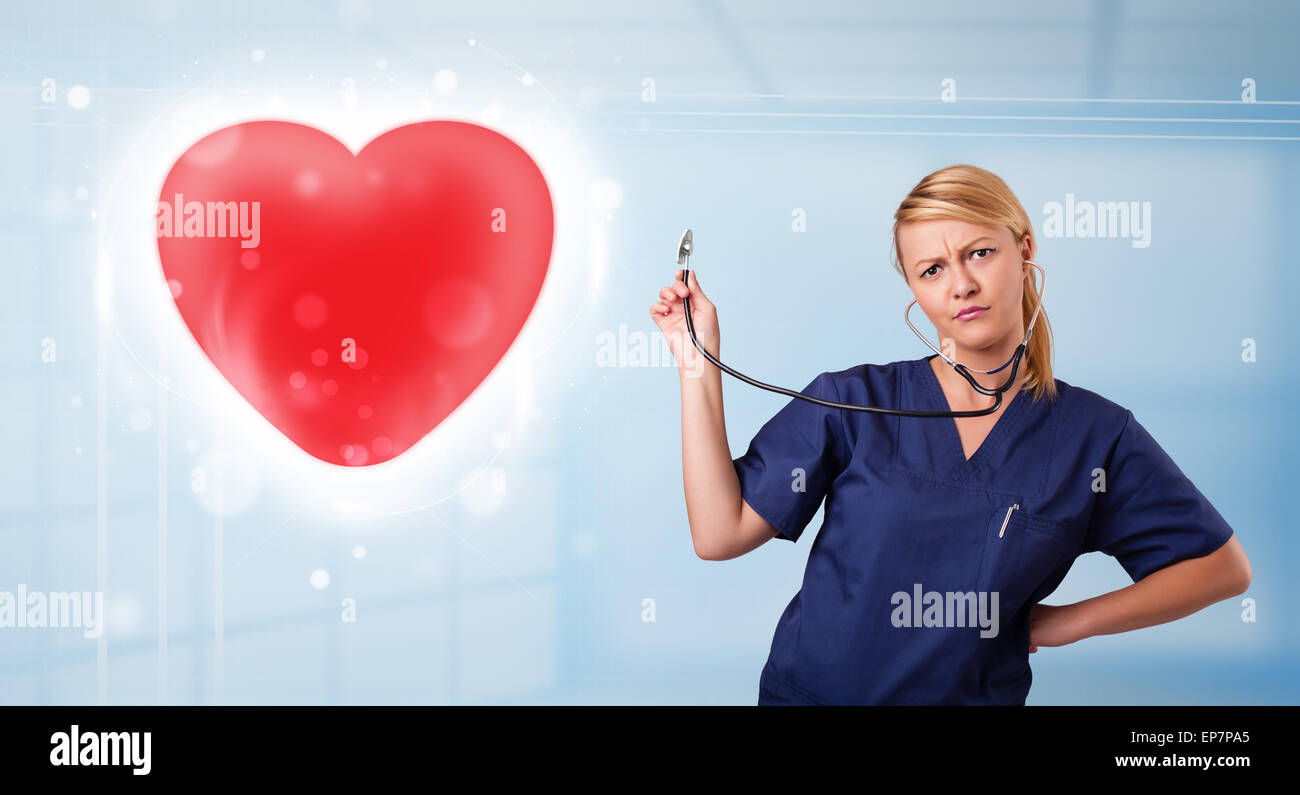 Young nurse healing a red heart Stock Photo - Alamy