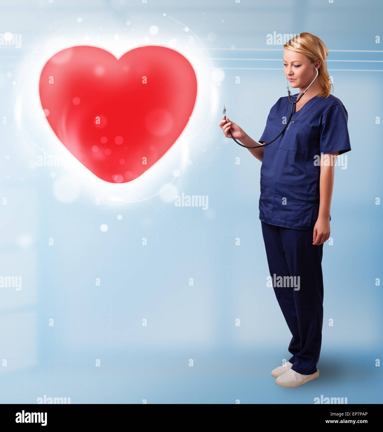 Young nurse healing a red heart Stock Photo - Alamy