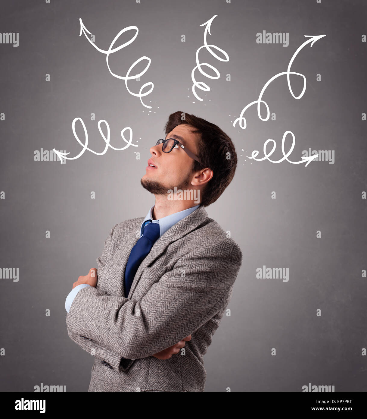 Young man thinking with arrows overhead Stock Photo - Alamy