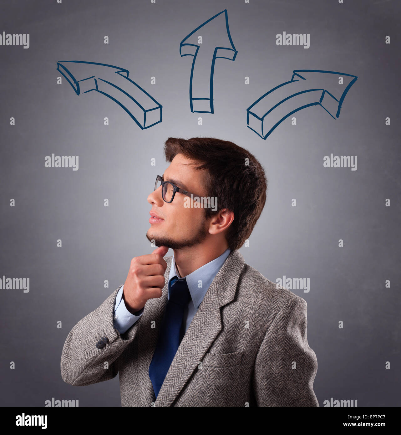 Handsome man thinking with arrows overhead Stock Photo - Alamy