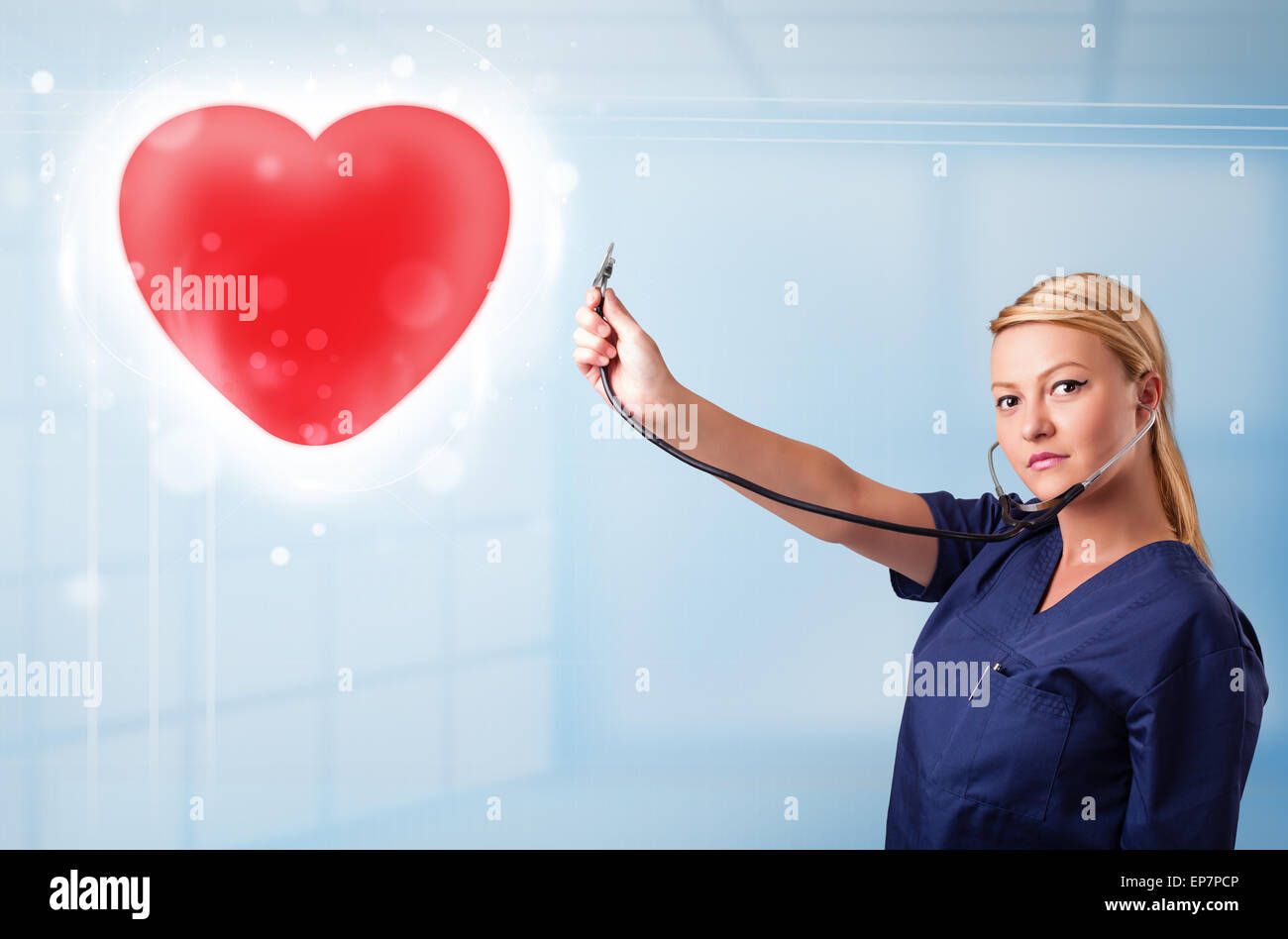 Young nurse healing a red heart Stock Photo - Alamy