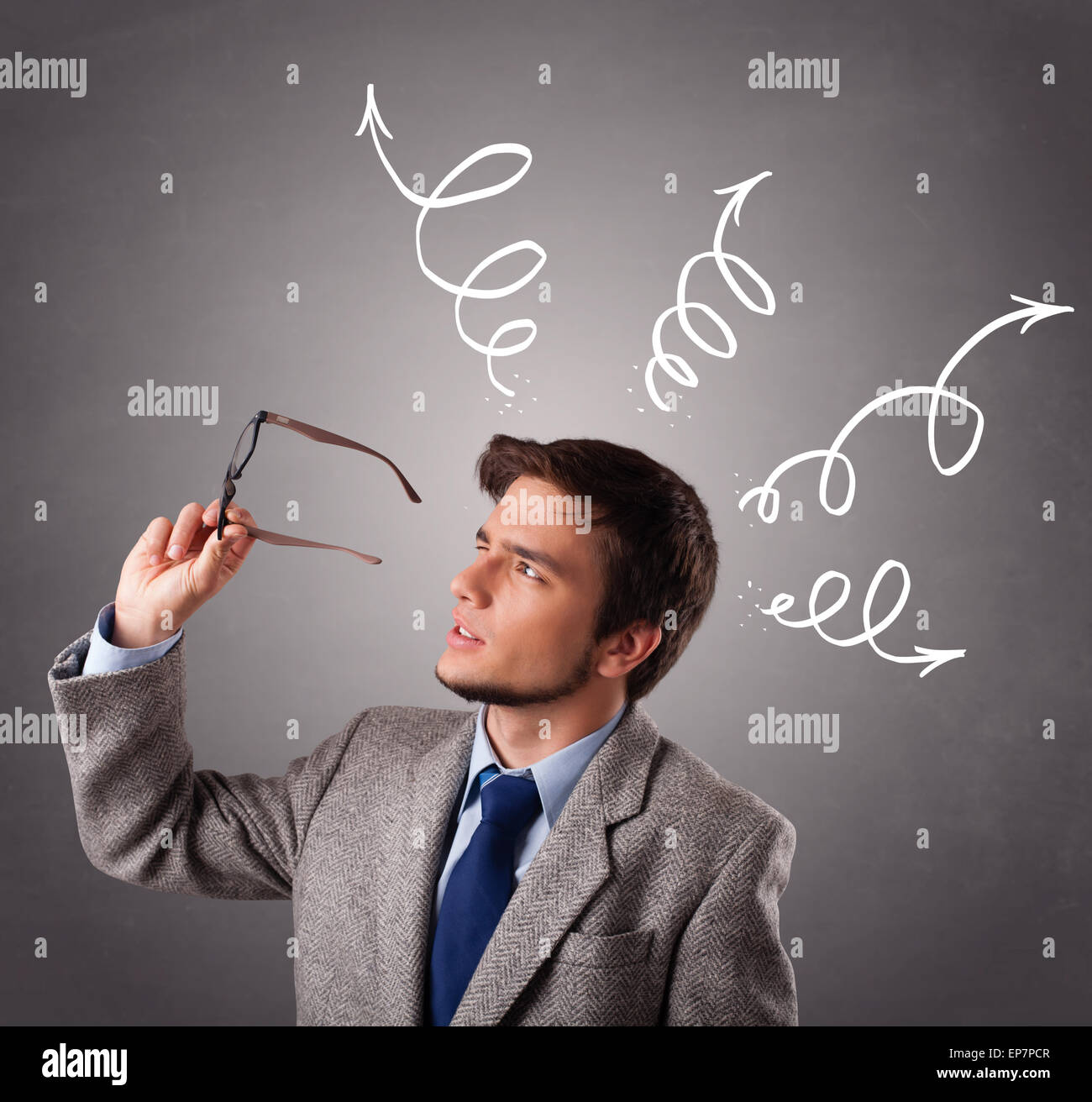 Young man thinking with arrows overhead Stock Photo - Alamy