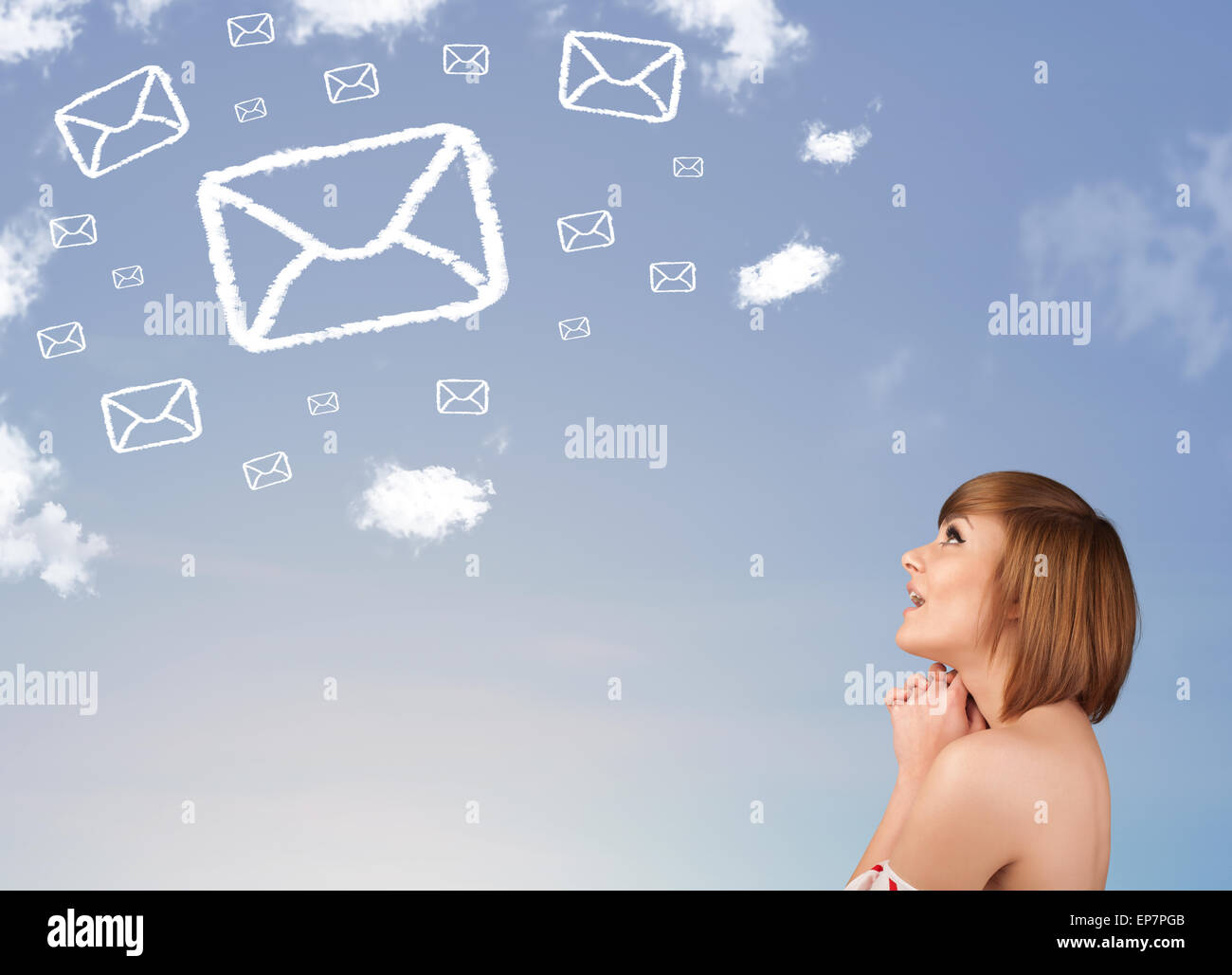 Young girl looking at mail symbol clouds on blue sky Stock Photo - Alamy