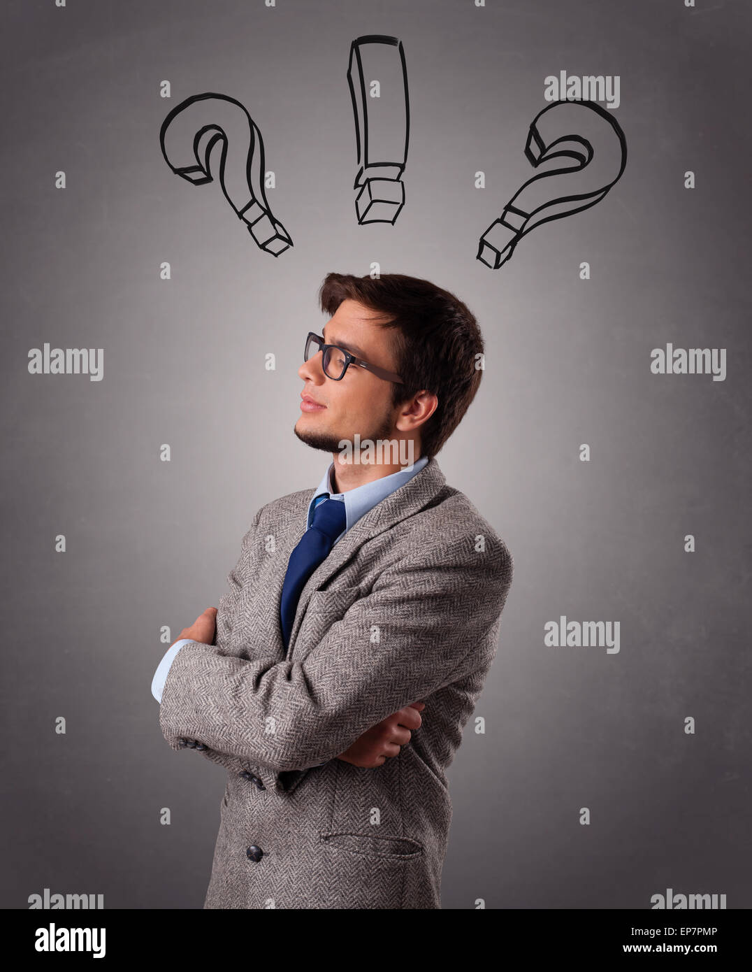 Young man thinking with question marks overhead Stock Photo - Alamy
