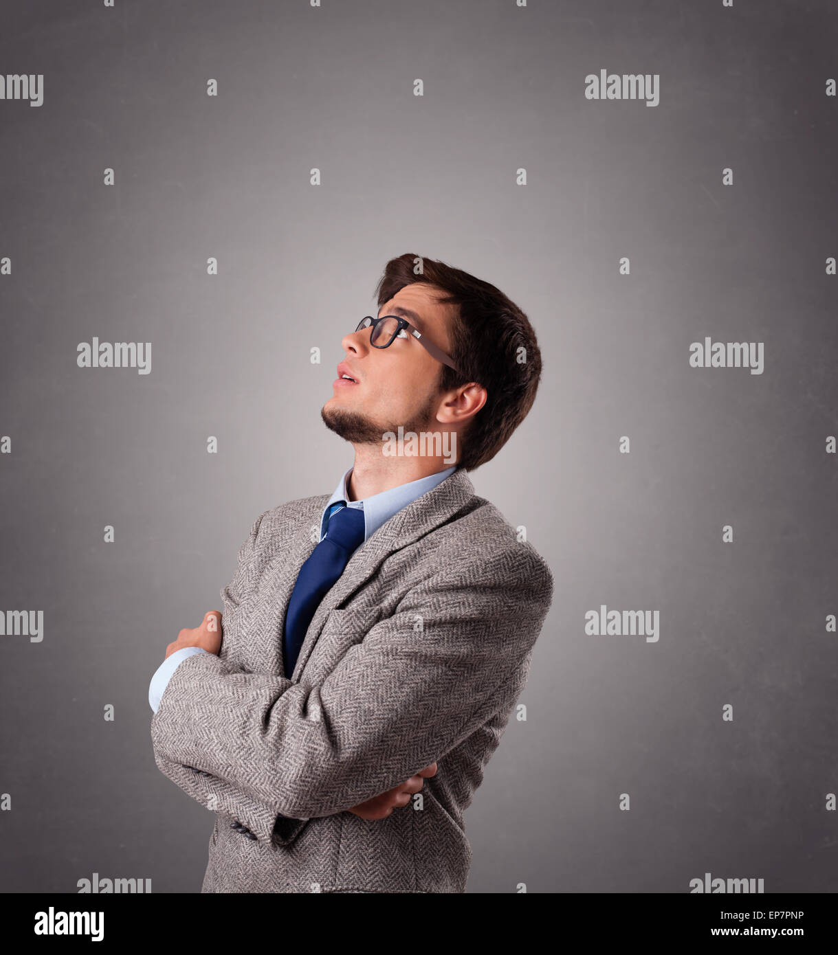 Attractive young man standing and thinking with copy space Stock Photo ...