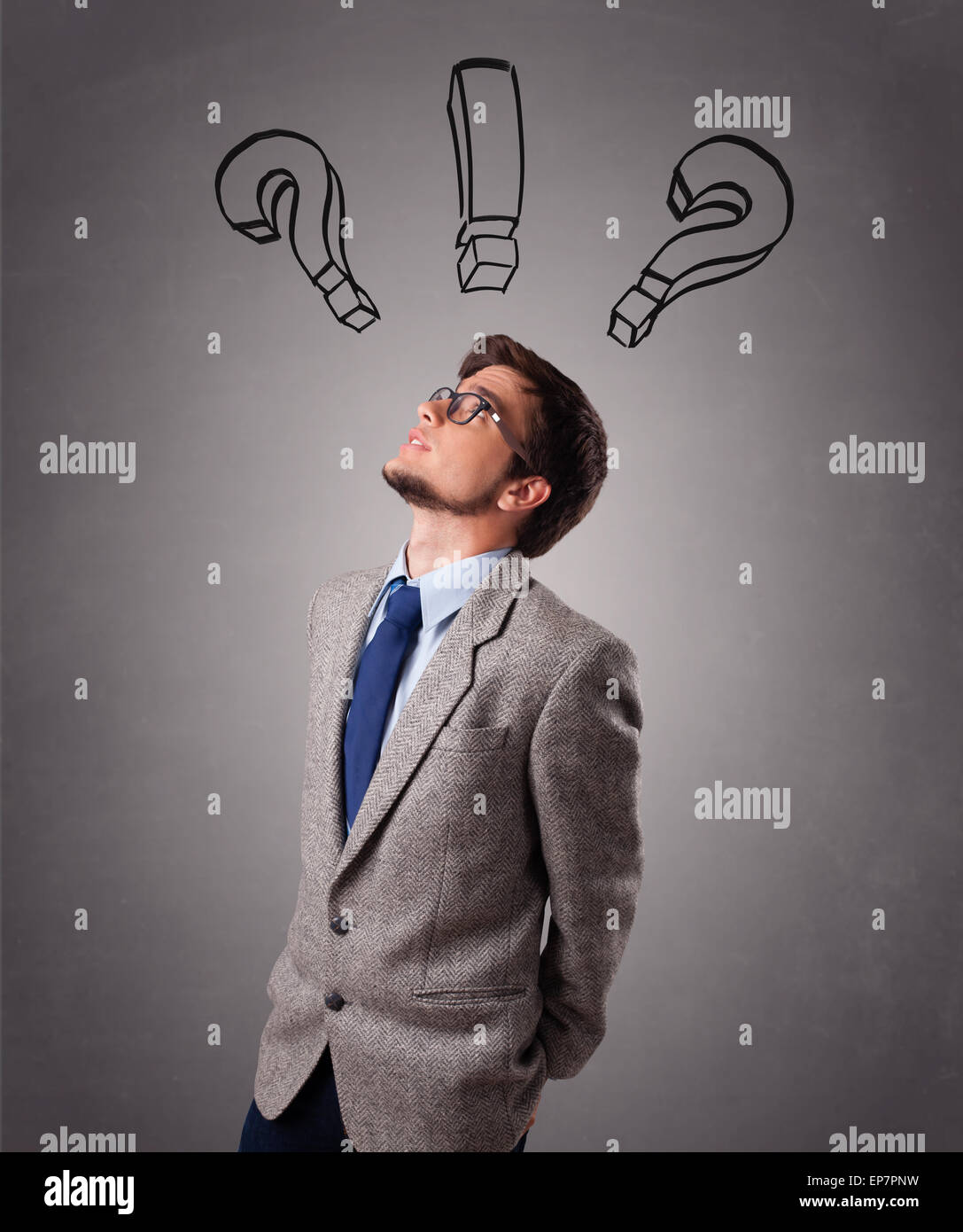 Young man thinking with question marks overhead Stock Photo - Alamy