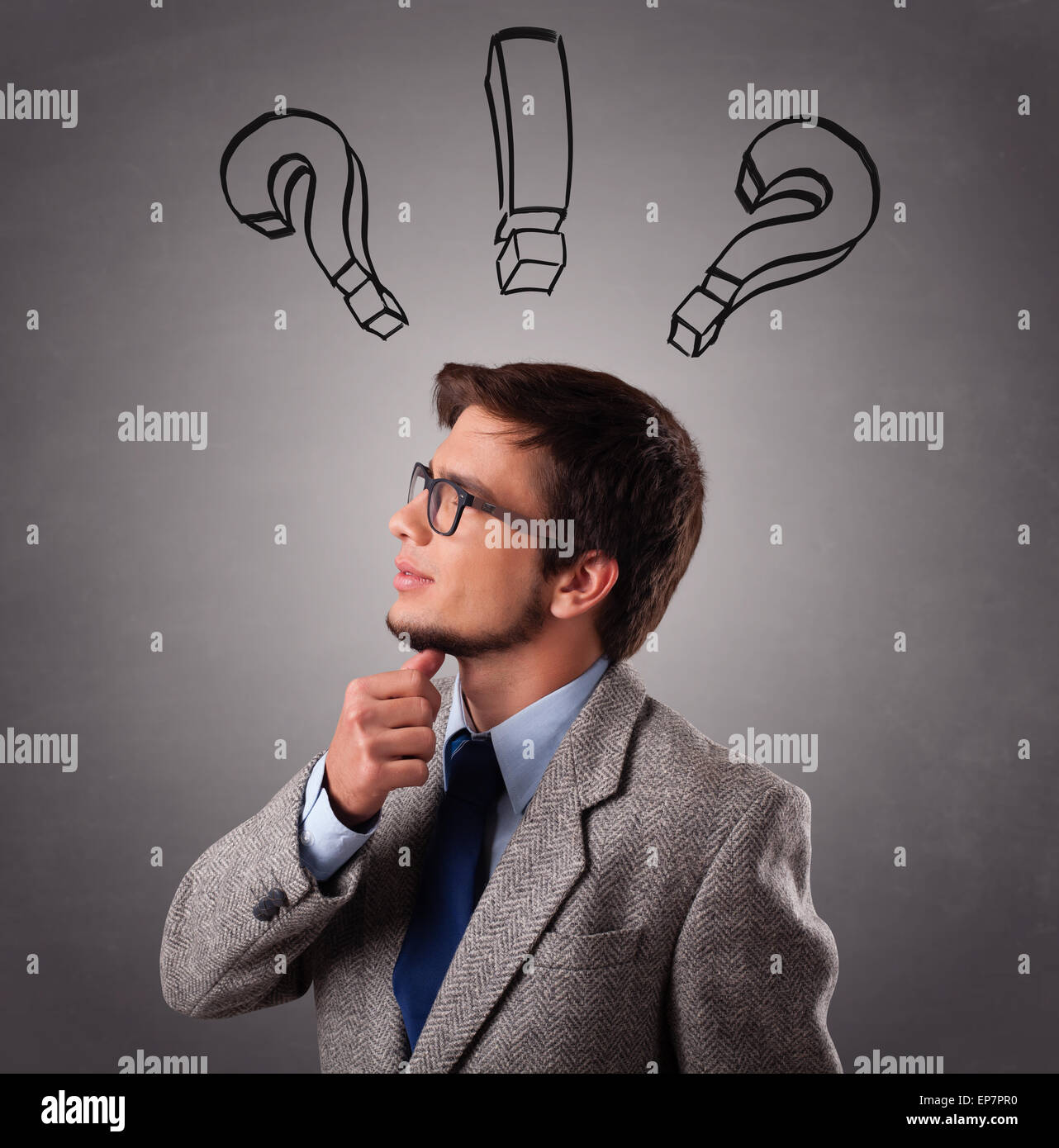 Young man thinking with question marks overhead Stock Photo - Alamy