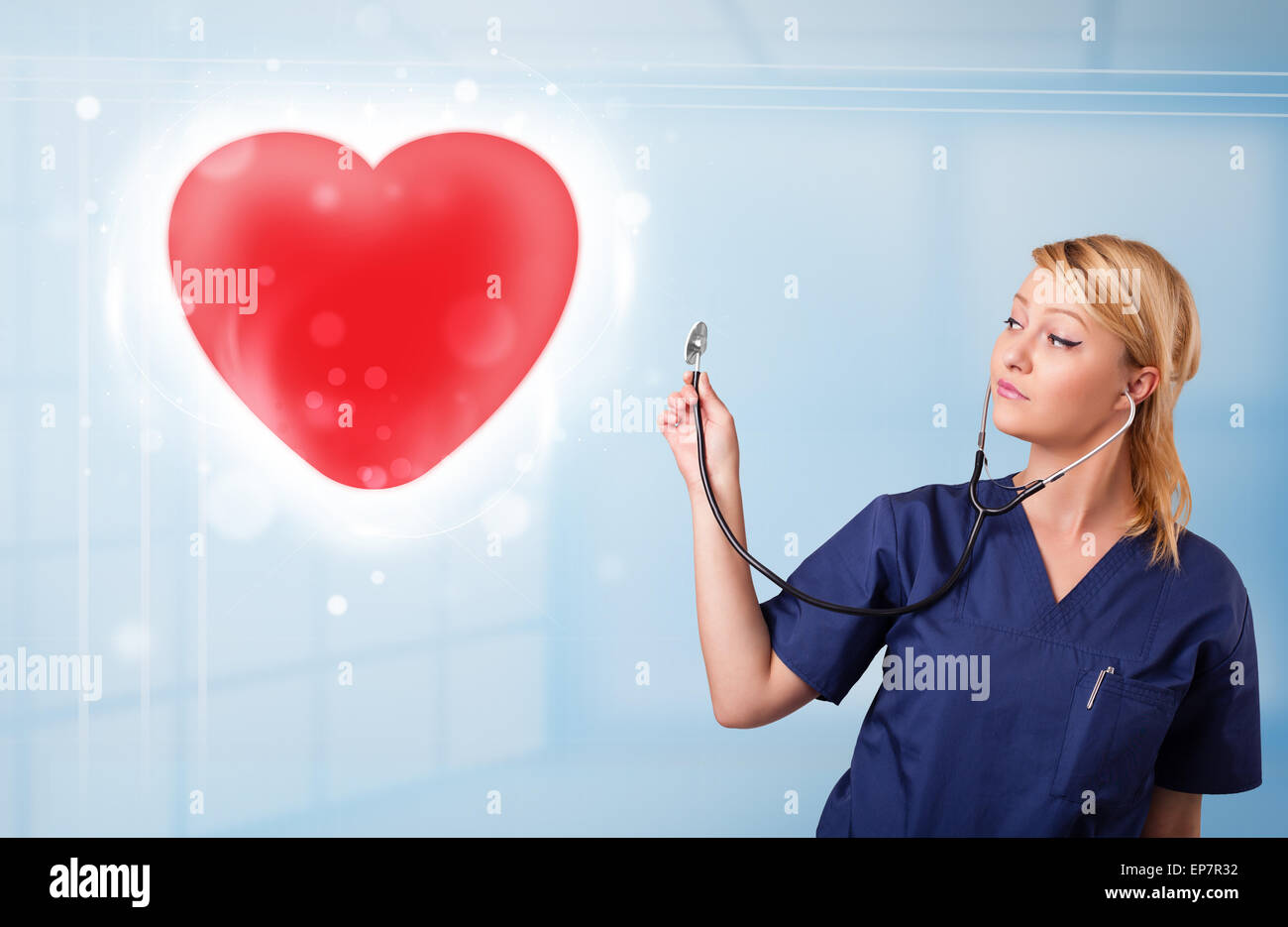 Young nurse healing a red heart Stock Photo - Alamy