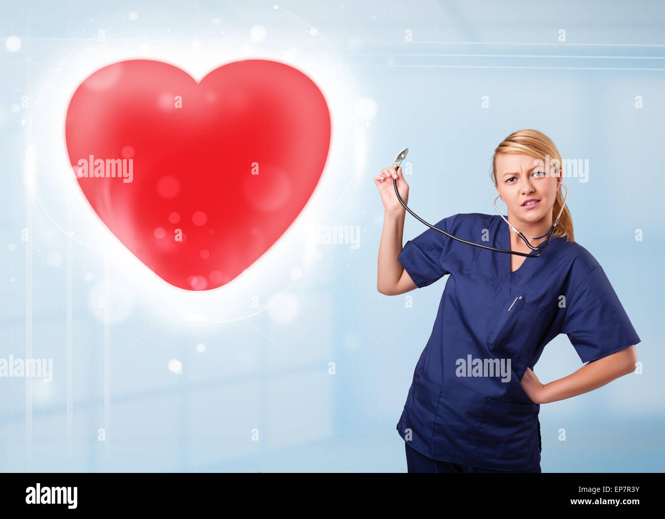 Young nurse healing a red heart Stock Photo - Alamy