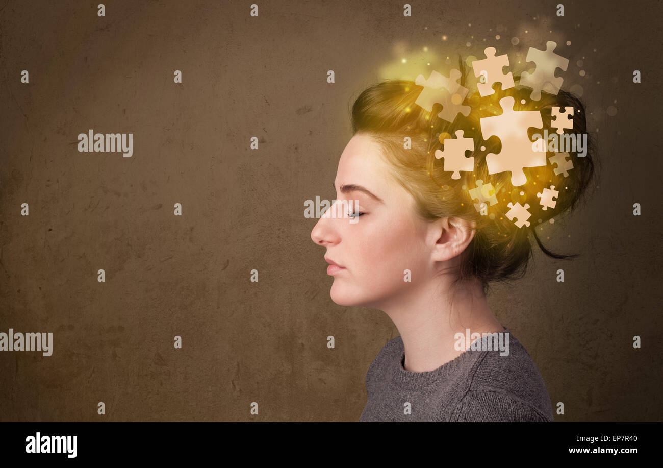 Young person thinking with glowing puzzle mind Stock Photo - Alamy