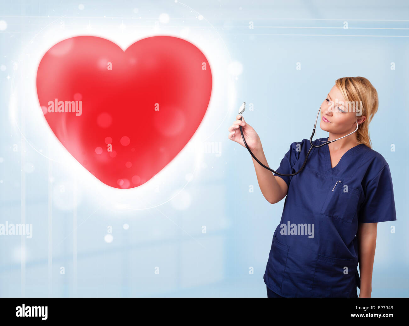 Young nurse healing a red heart Stock Photo - Alamy