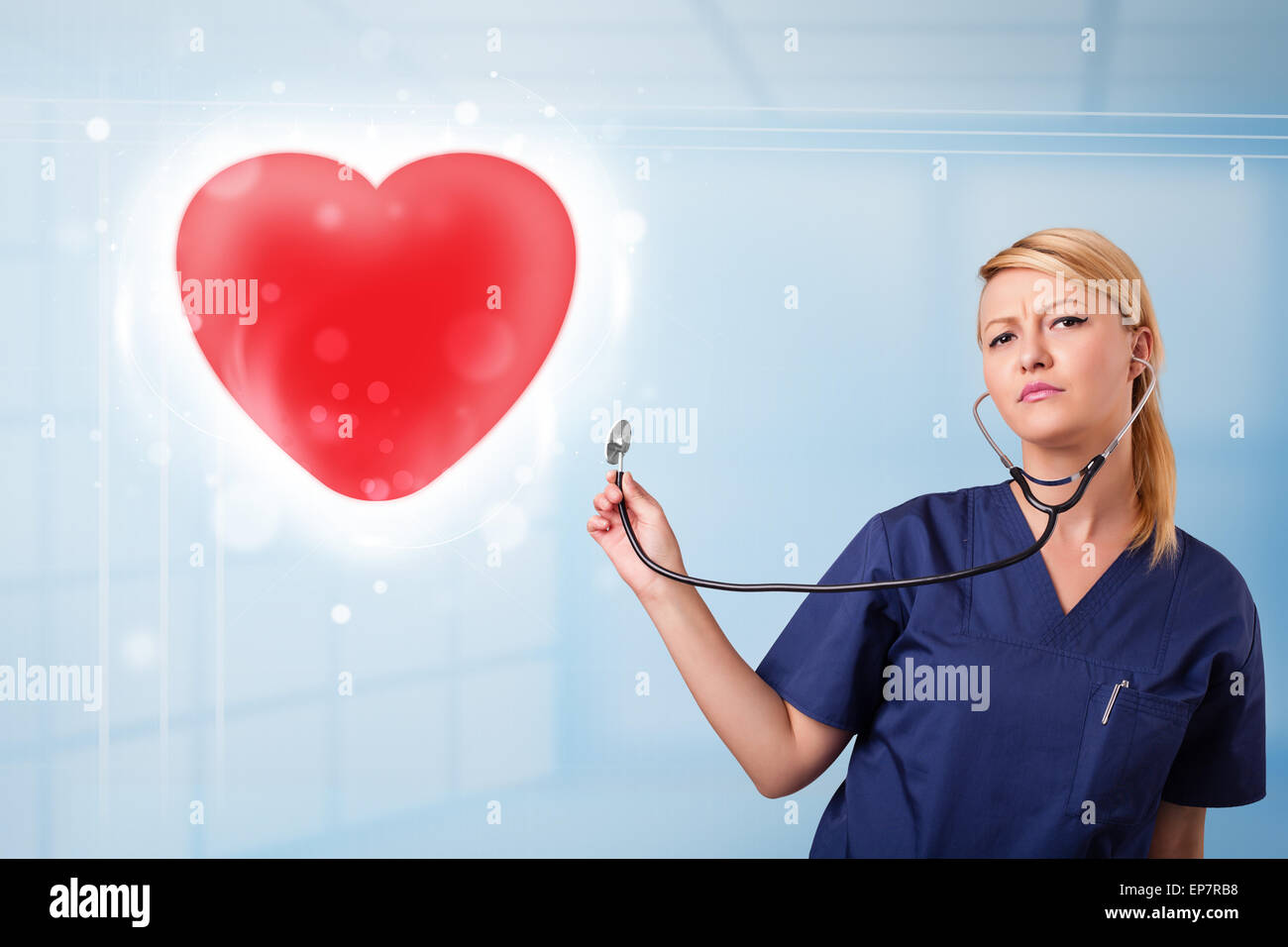 Young nurse healing a red heart Stock Photo - Alamy