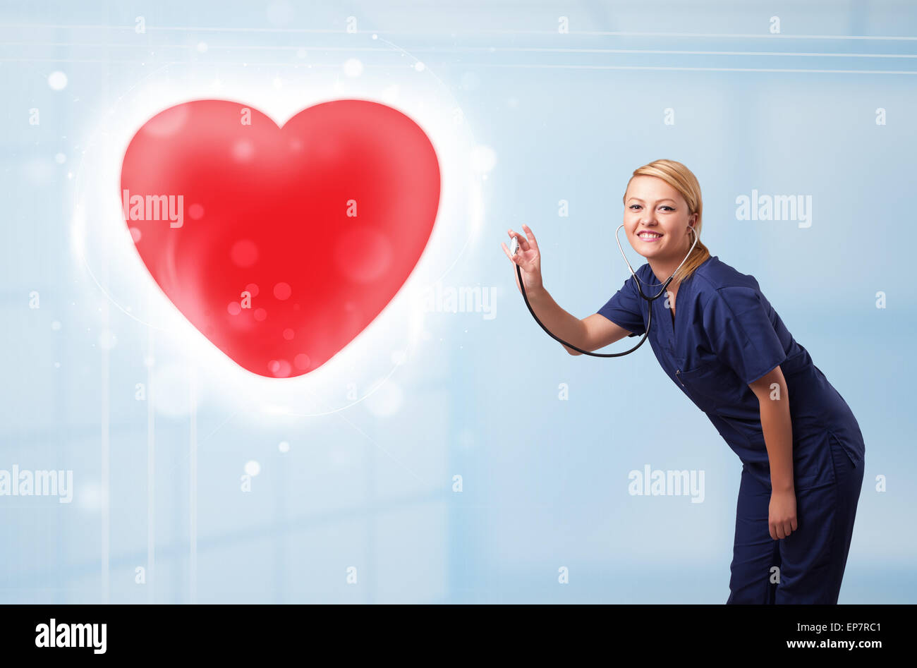 Young nurse healing a red heart Stock Photo - Alamy