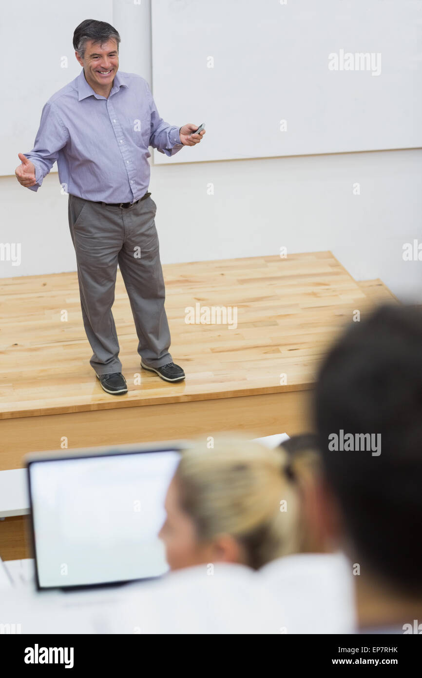 Explaining teacher standing in a lecture hall Stock Photo - Alamy