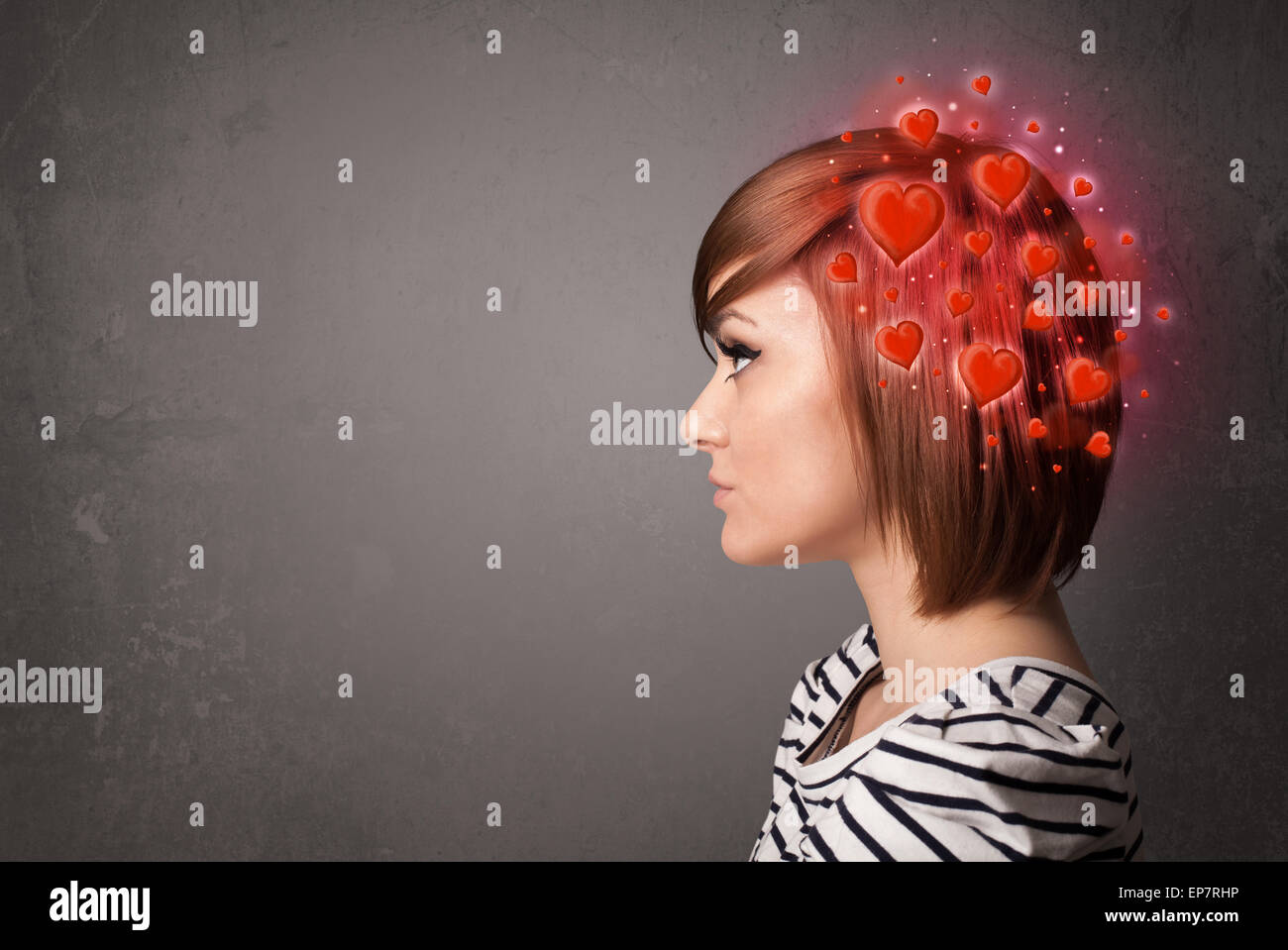 Young person thinking about love with red hearts Stock Photo - Alamy