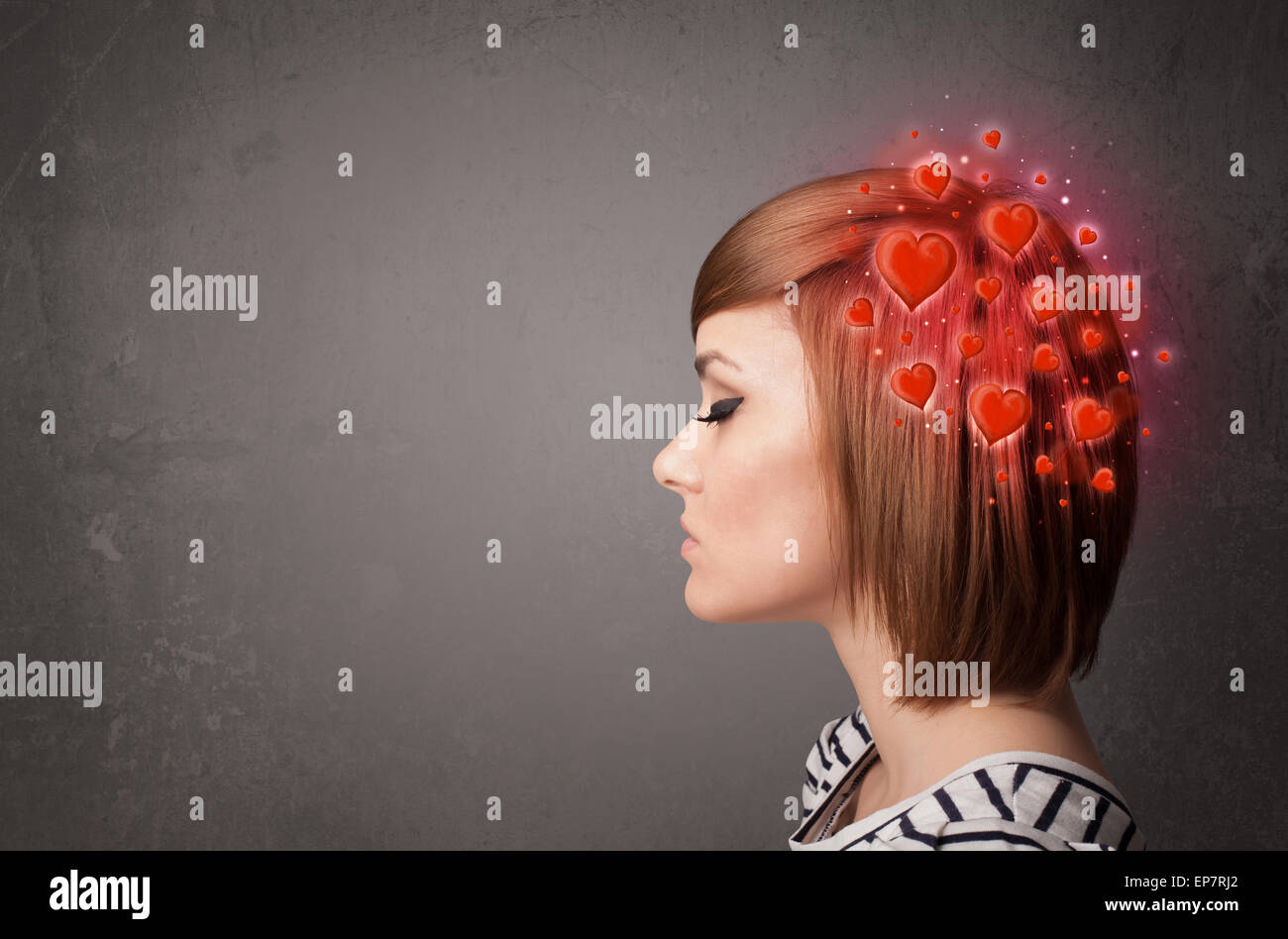 Young person thinking about love with red hearts Stock Photo - Alamy