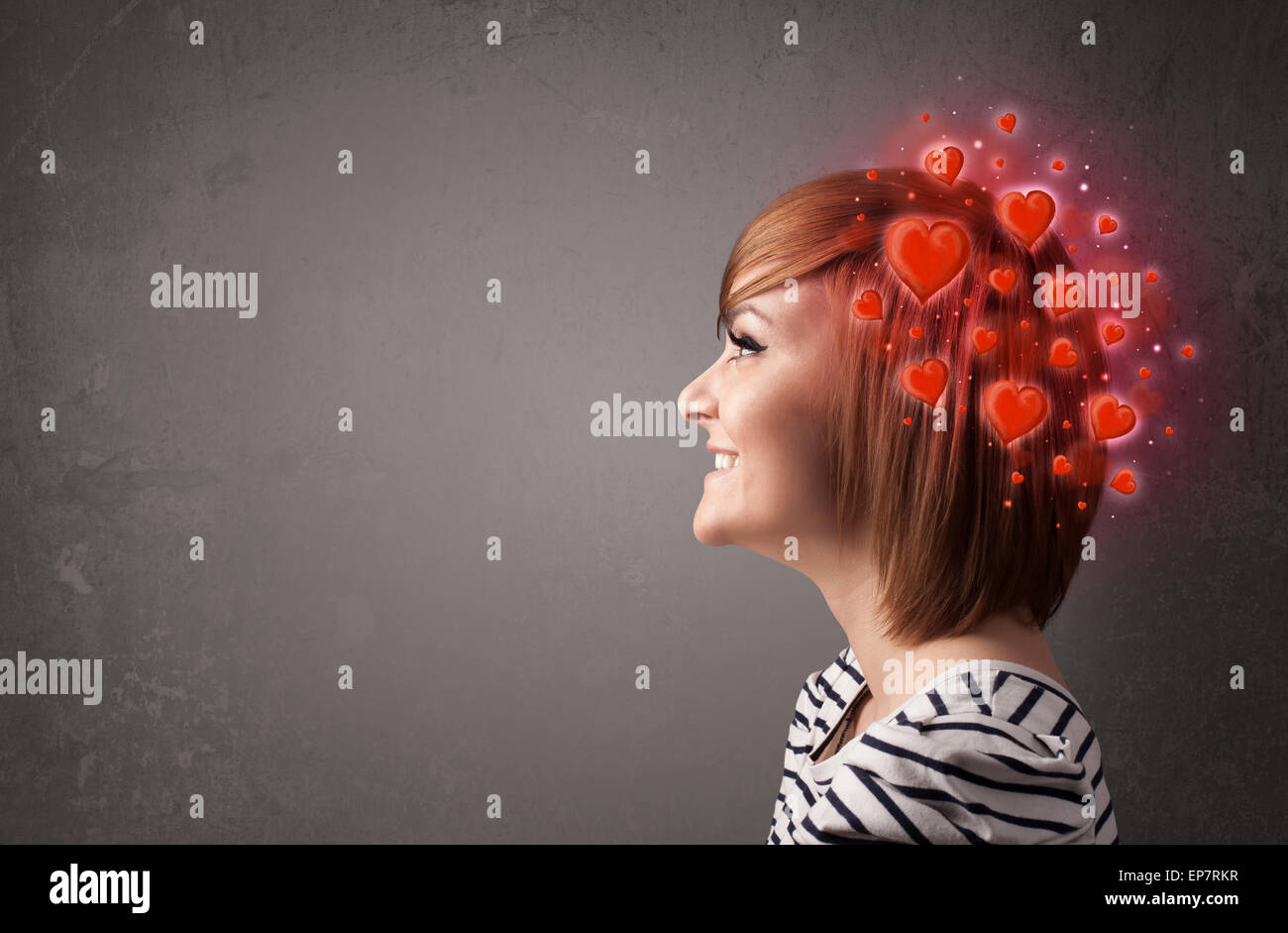 Young person thinking about love with red hearts Stock Photo - Alamy