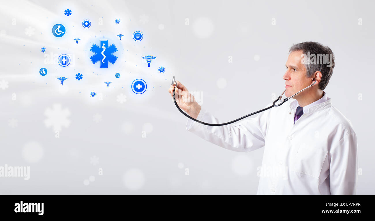 Doctor with blue medical icons Stock Photo - Alamy