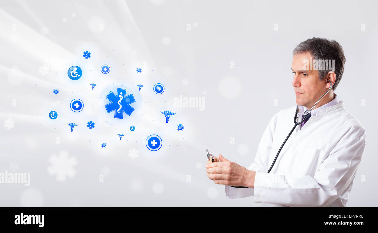 Doctor with blue medical icons Stock Photo - Alamy