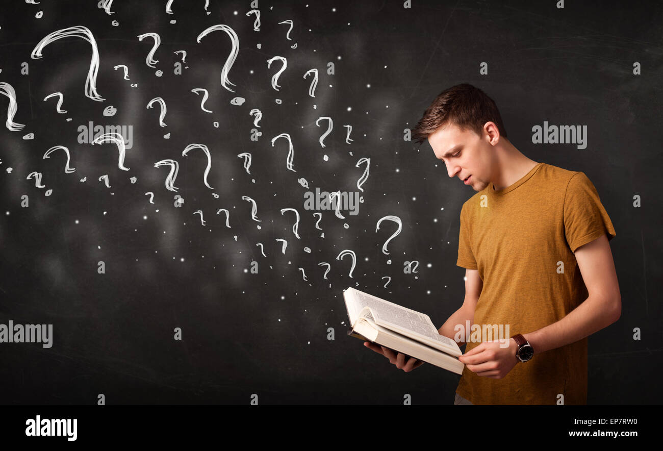 Young man reading a book with question marks coming out from it Stock ...