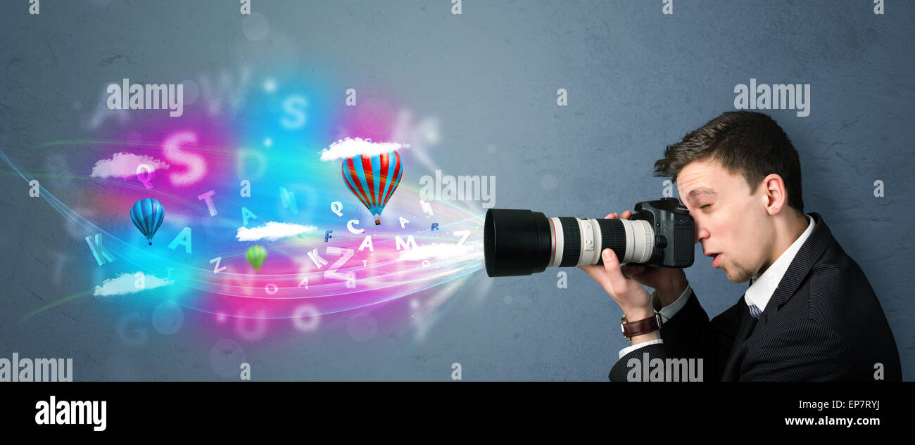 Handsome photographer with camera and abstract imaginary Stock Photo ...