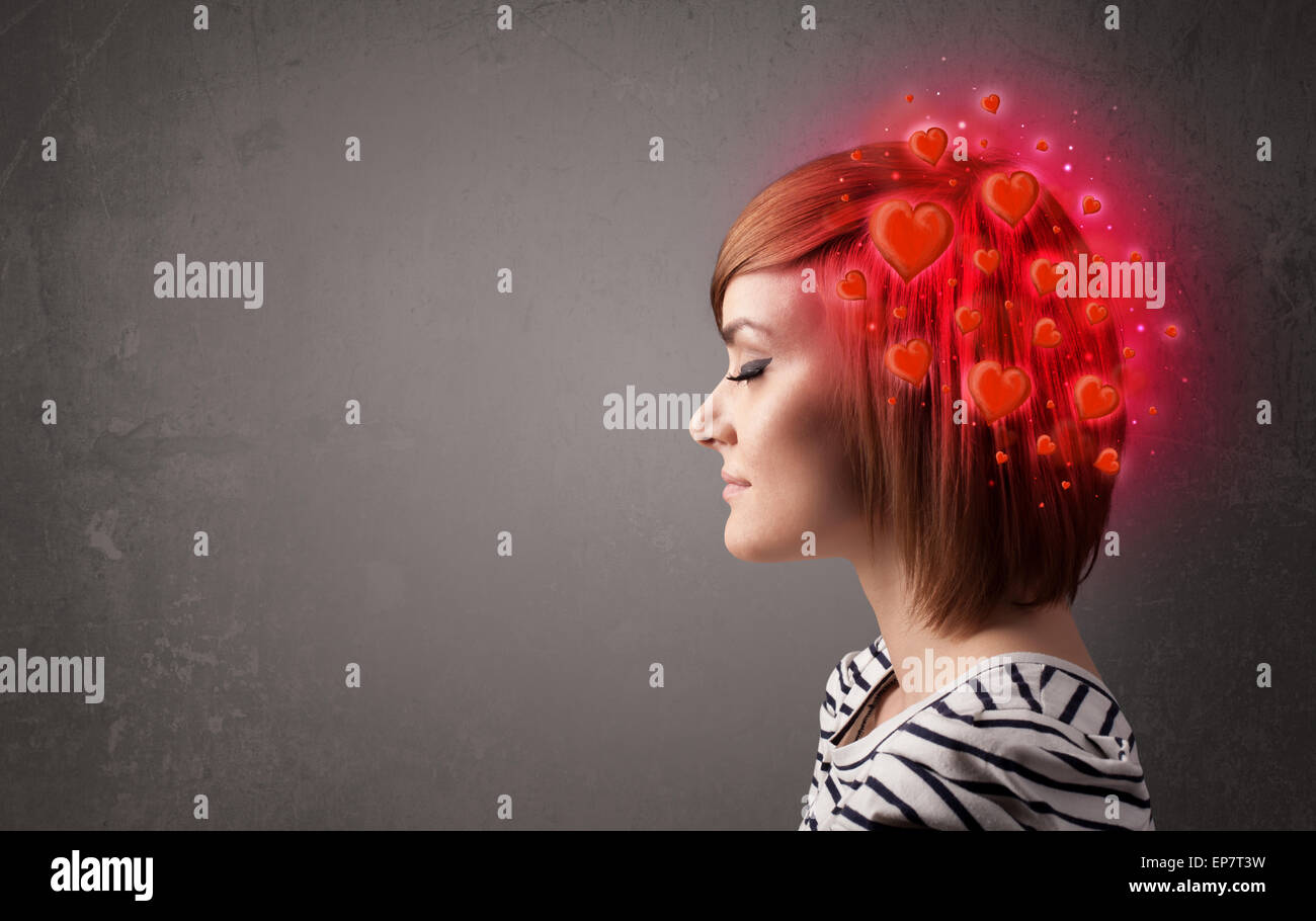 Young person thinking about love with red hearts Stock Photo - Alamy