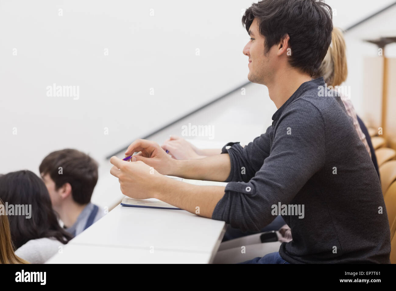 Student sitting in a lecture hall and listening the teacher Stock Photo ...