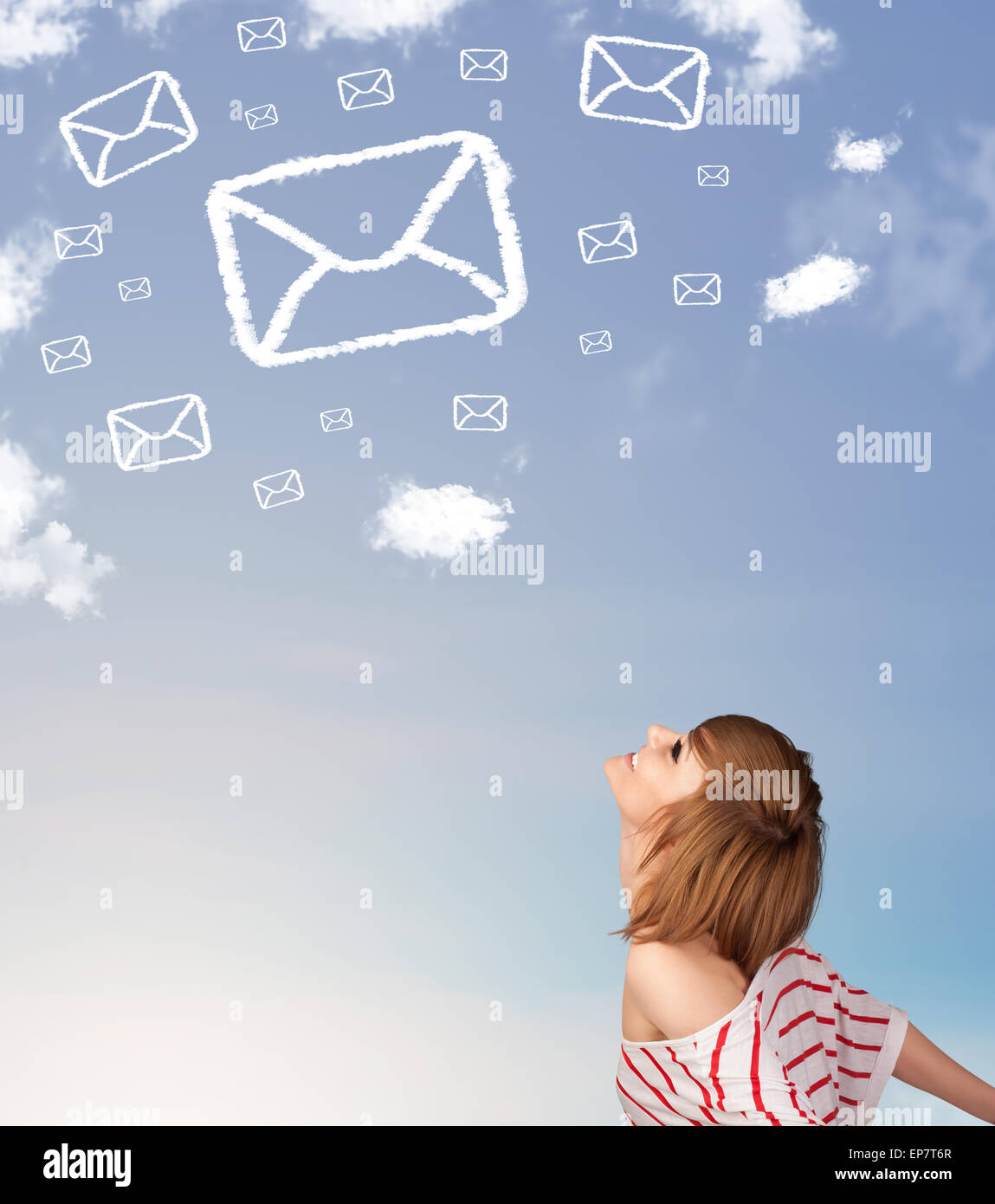 Young girl looking at mail symbol clouds on blue sky Stock Photo - Alamy