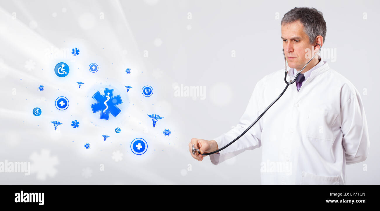 Doctor with blue medical icons Stock Photo - Alamy