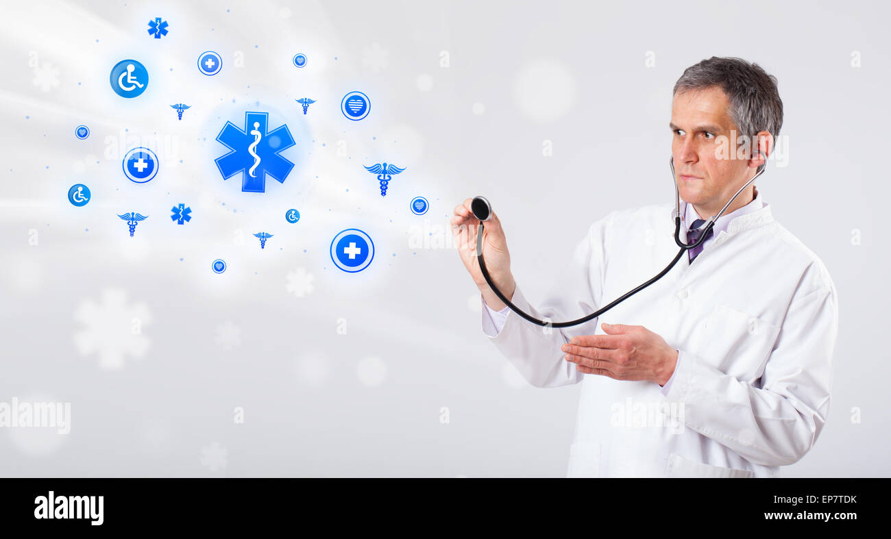 Doctor with blue medical icons Stock Photo - Alamy