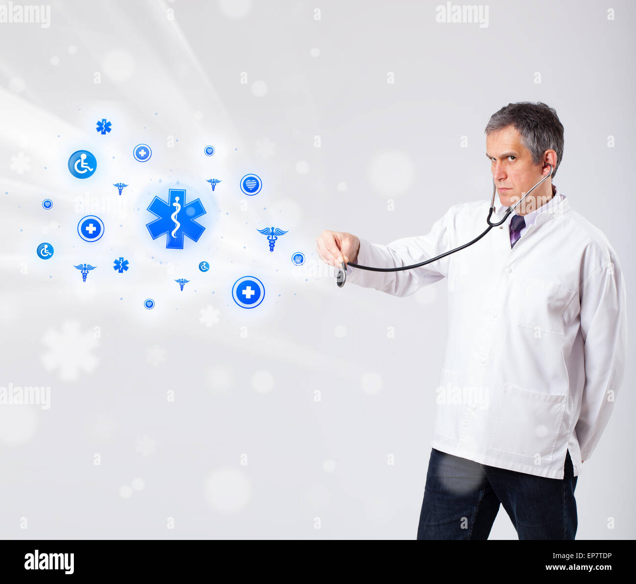 Doctor with blue medical icons Stock Photo - Alamy