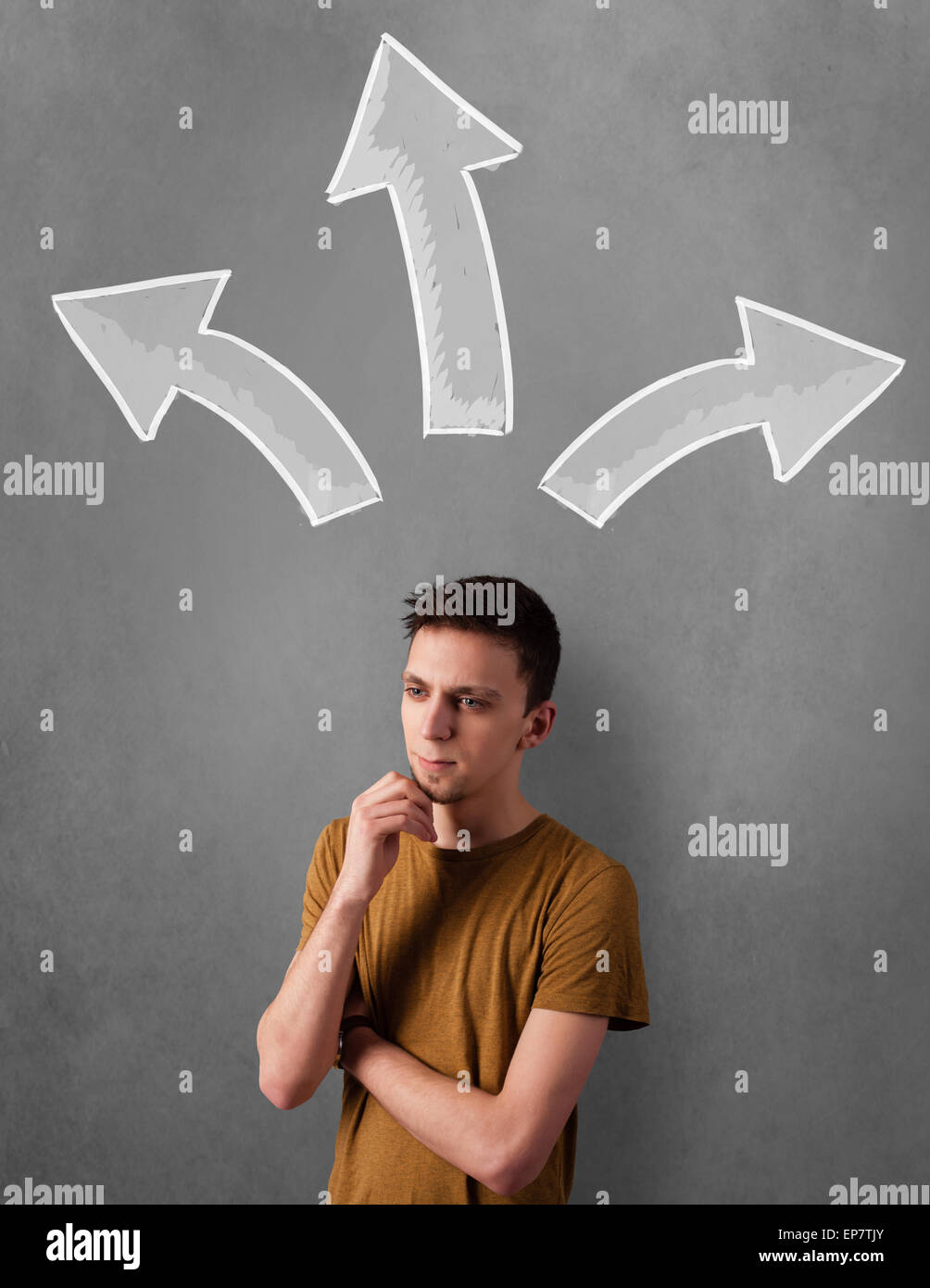 Young man thinking with arrows above his head Stock Photo - Alamy