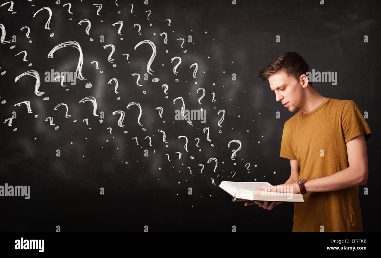 Young man reading a book with question marks coming out from it Stock ...