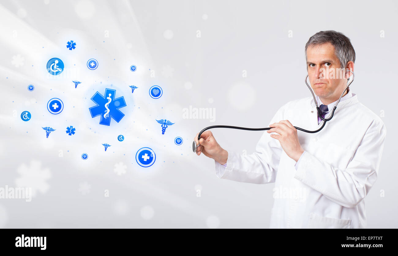 Doctor with blue medical icons Stock Photo - Alamy