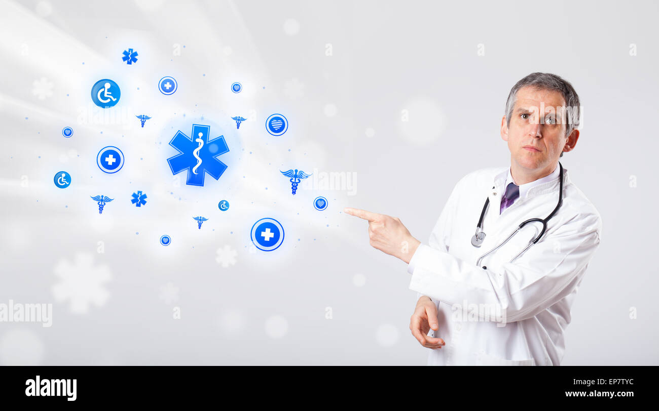 Doctor with blue medical icons Stock Photo - Alamy