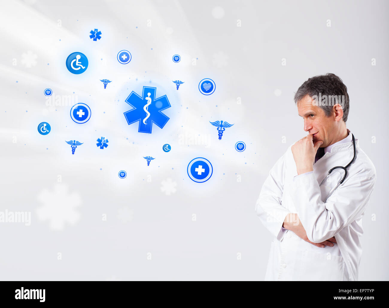 Doctor with blue medical icons Stock Photo - Alamy