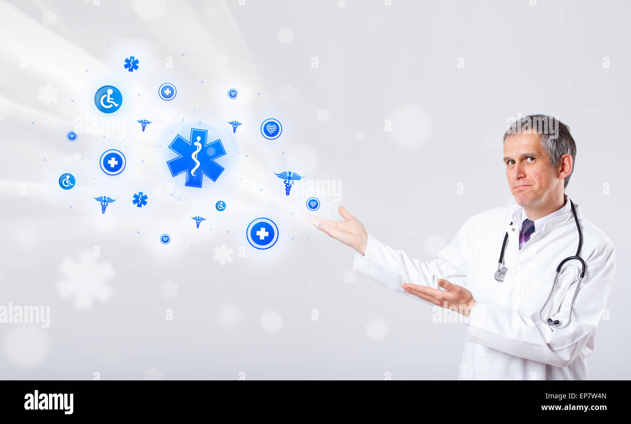 Doctor with blue medical icons Stock Photo - Alamy