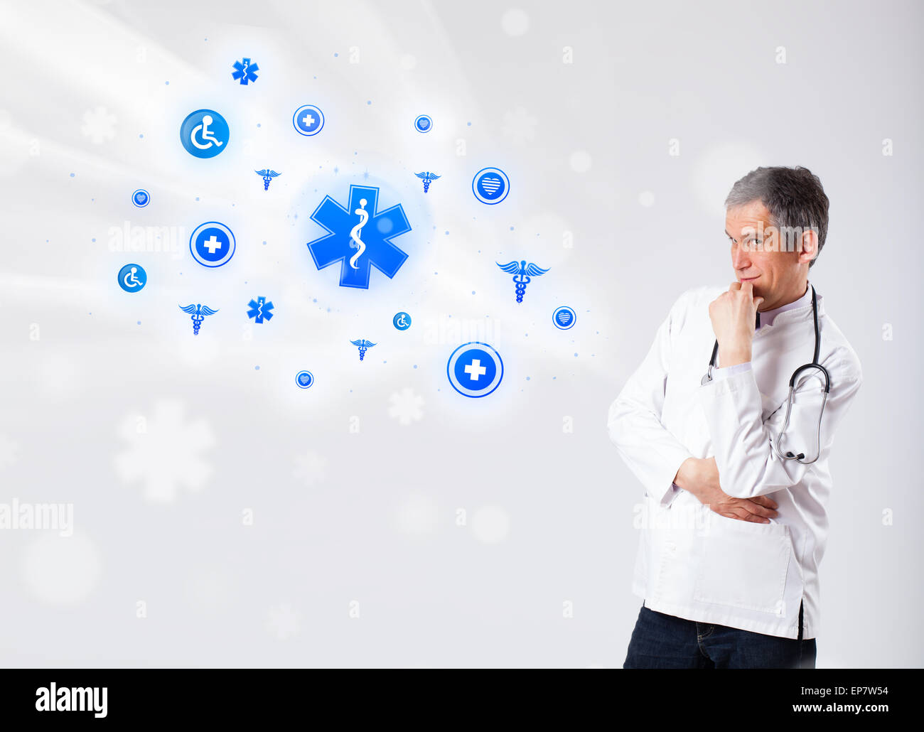 Doctor with blue medical icons Stock Photo - Alamy