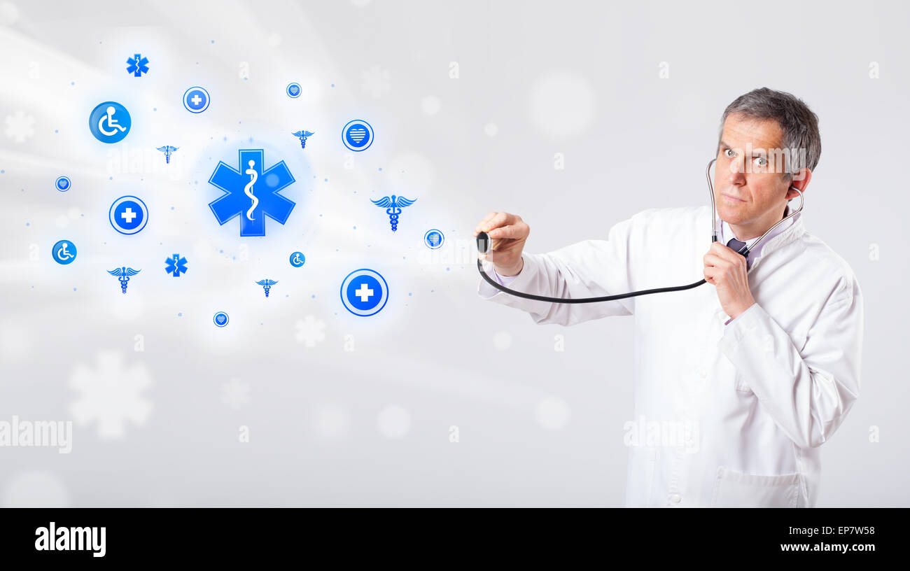 Doctor with blue medical icons Stock Photo - Alamy