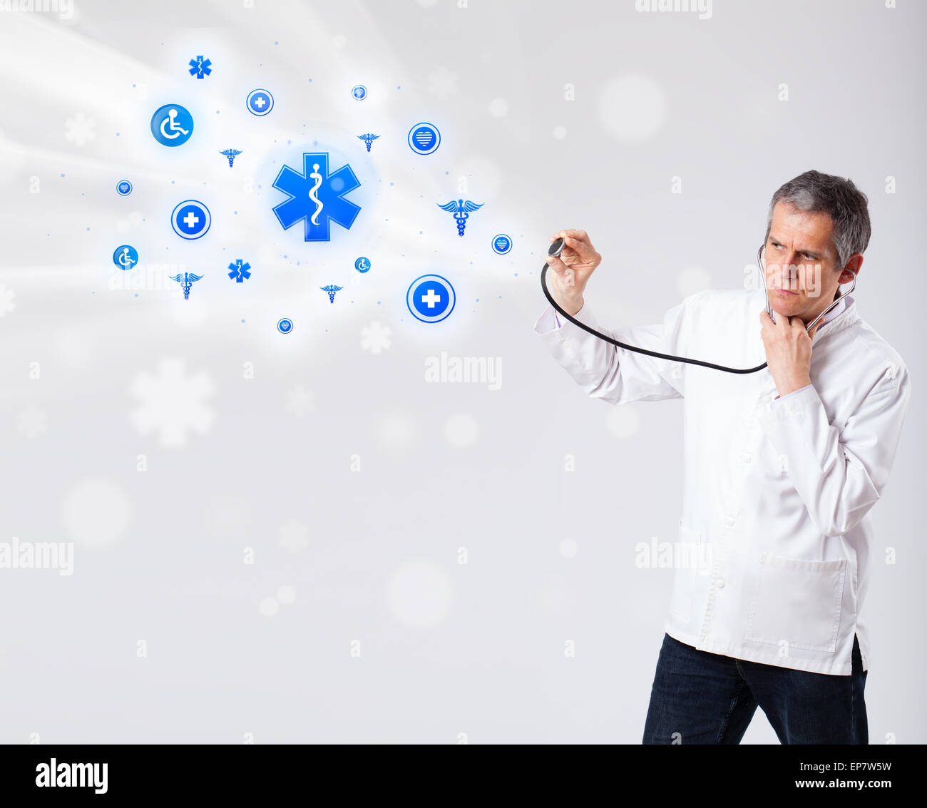 Doctor with blue medical icons Stock Photo - Alamy