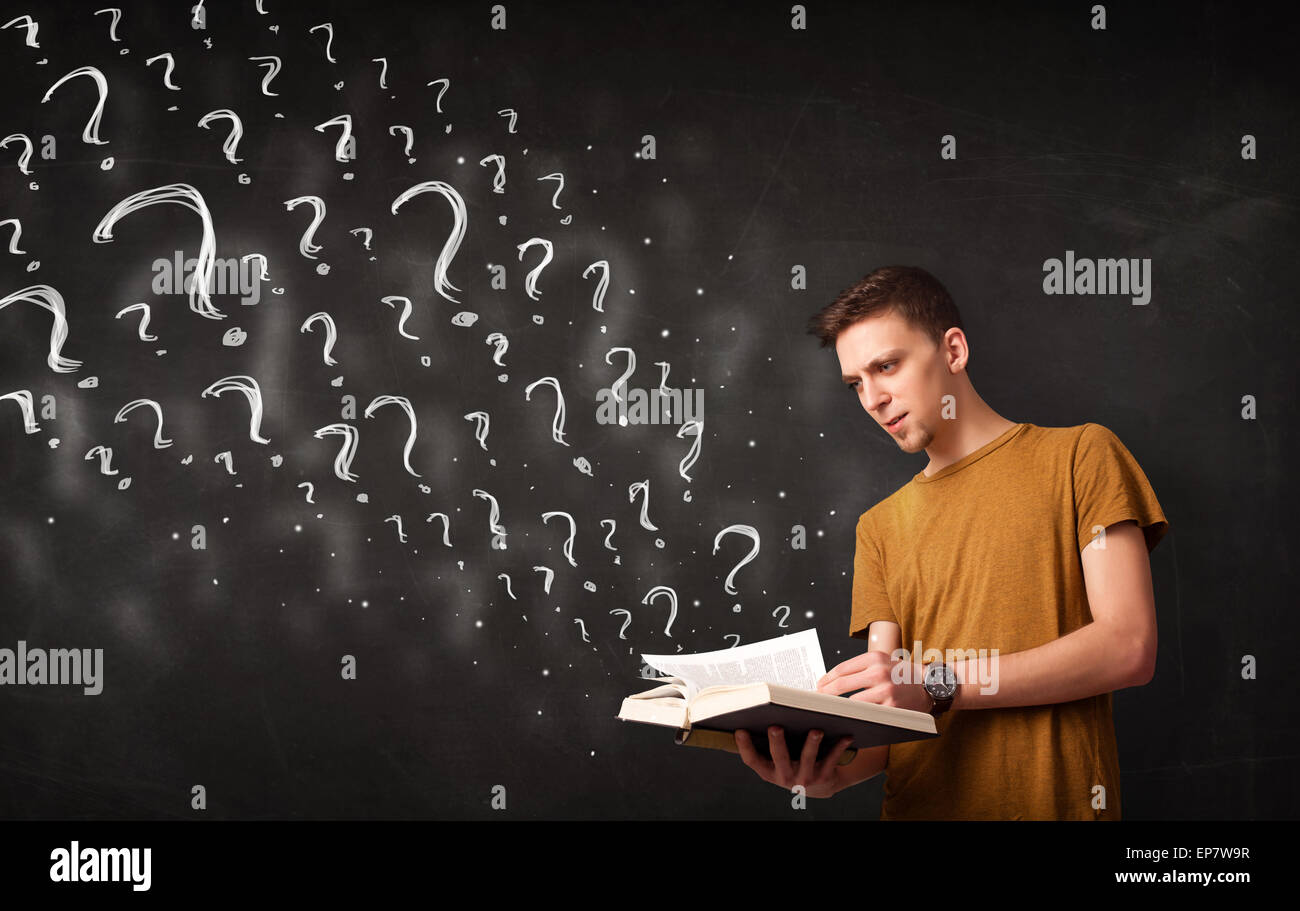 Young man reading a book with question marks coming out from it Stock ...