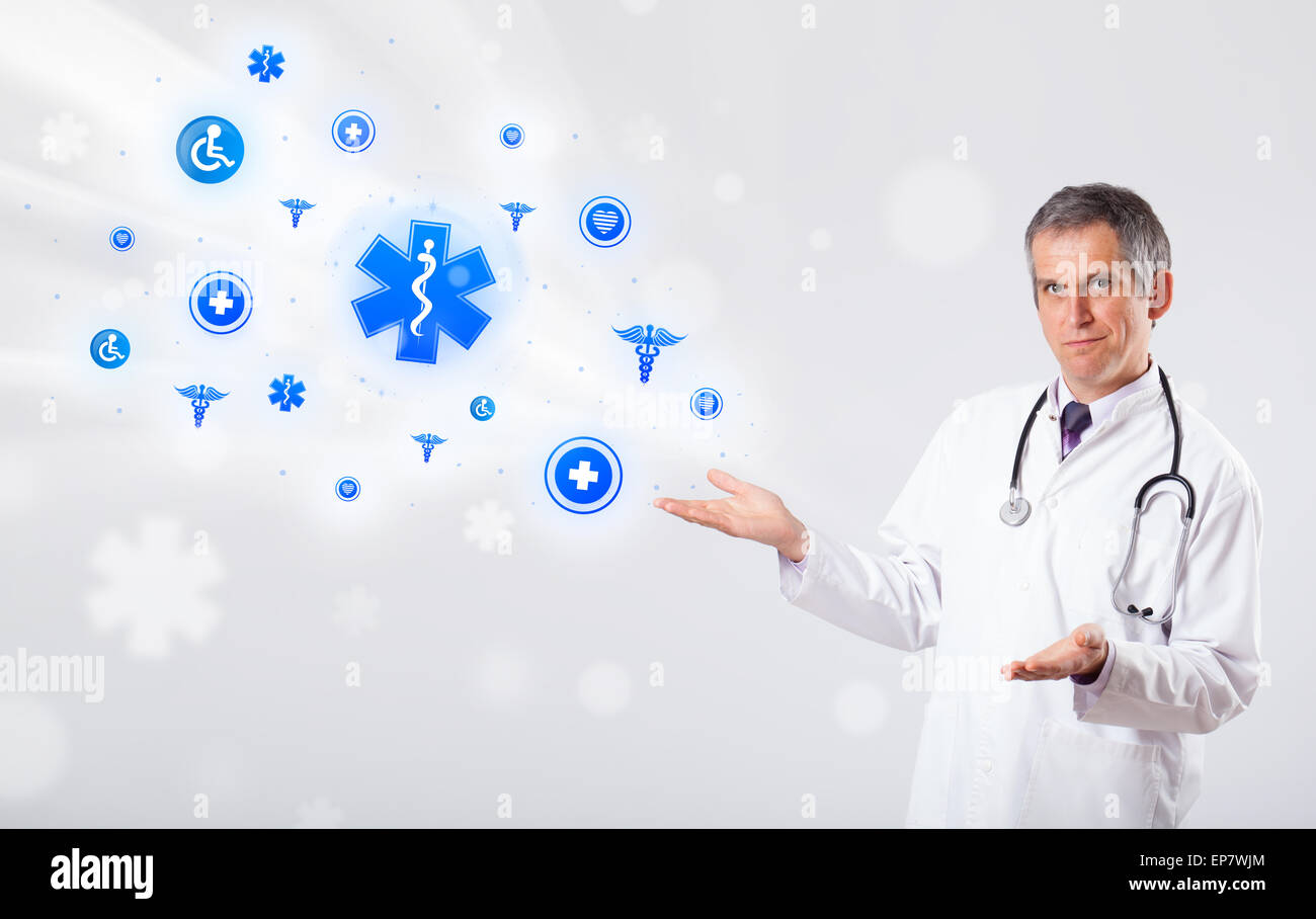 Doctor with blue medical icons Stock Photo - Alamy