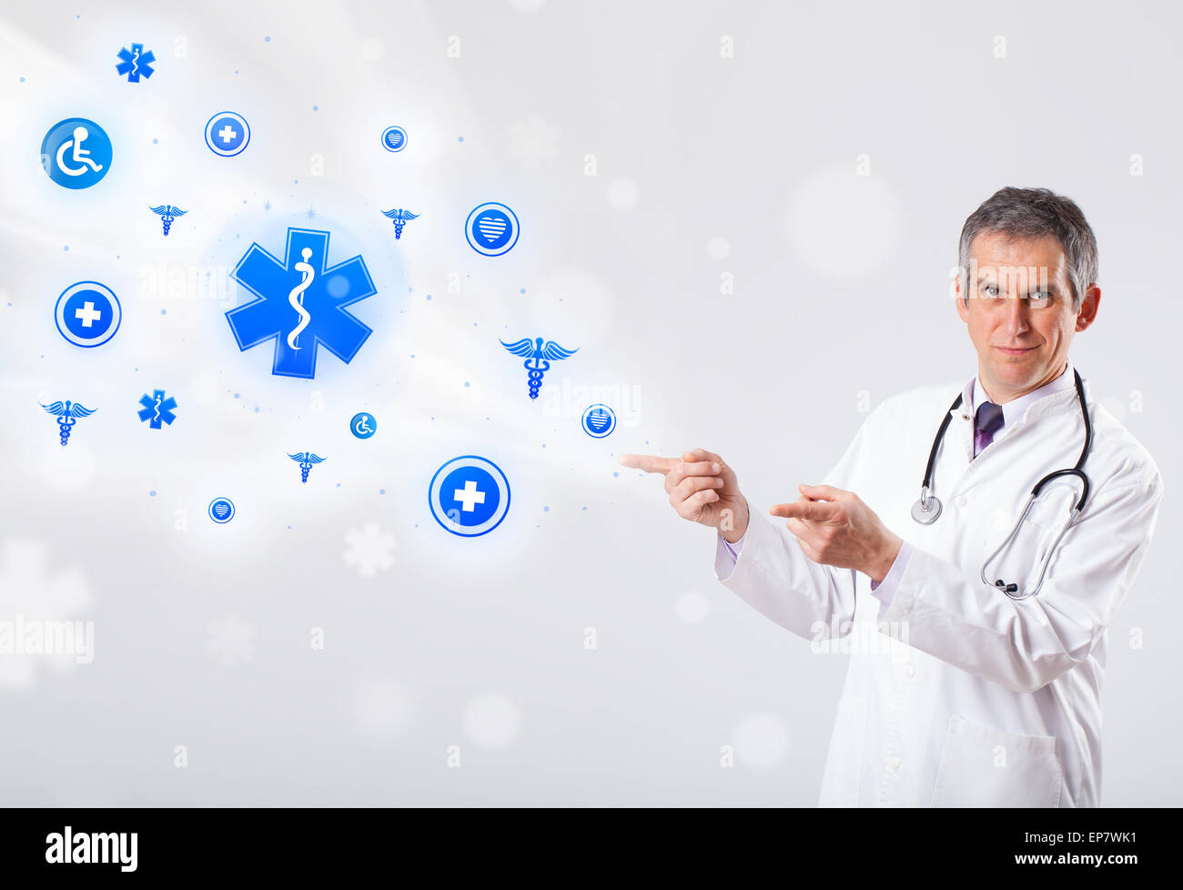 Doctor with blue medical icons Stock Photo - Alamy