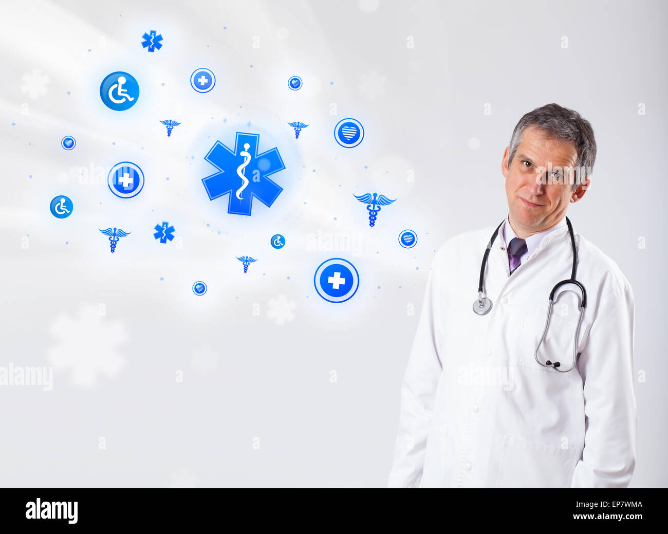 Doctor with blue medical icons Stock Photo - Alamy
