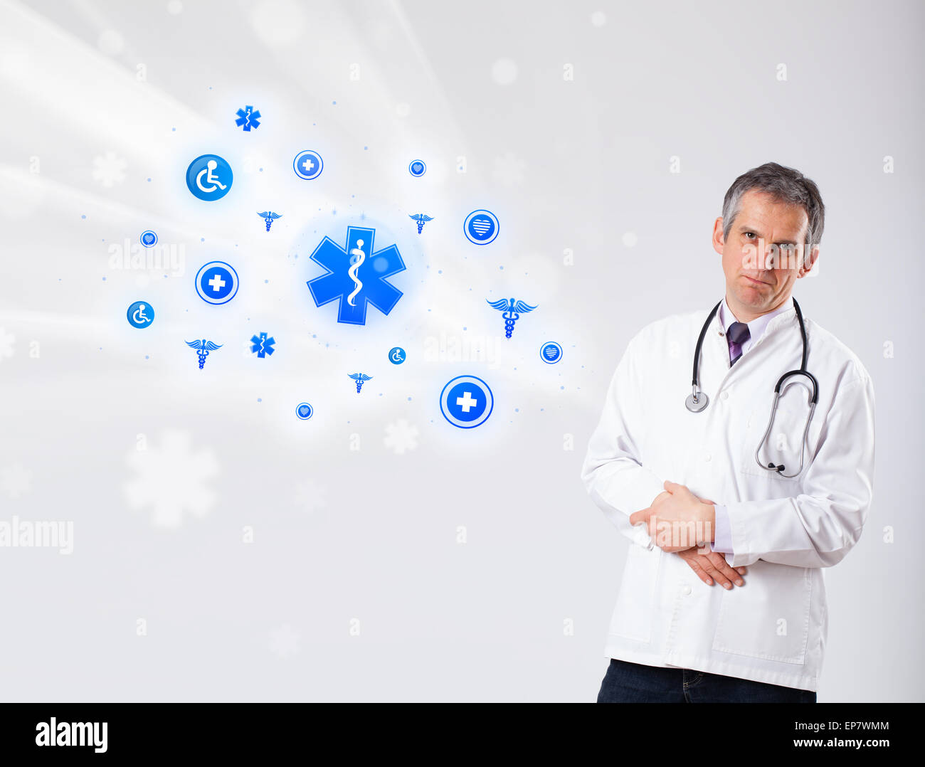 Doctor with blue medical icons Stock Photo - Alamy