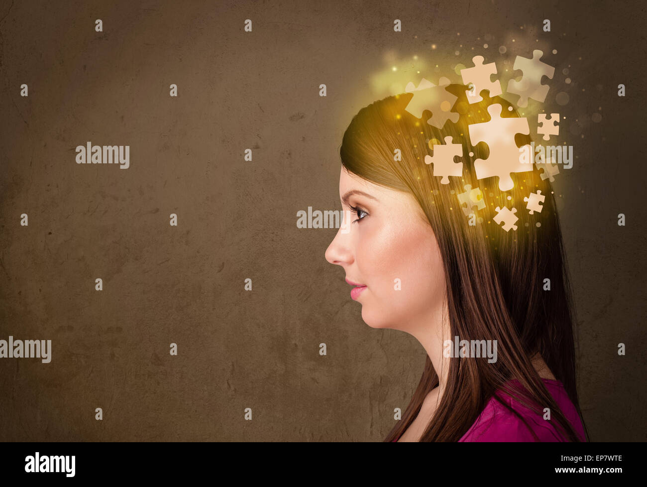 Young person thinking with glowing puzzle mind Stock Photo - Alamy