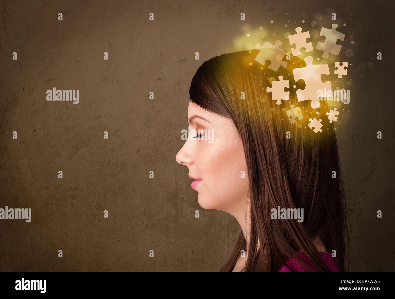 Young person thinking with glowing puzzle mind Stock Photo - Alamy