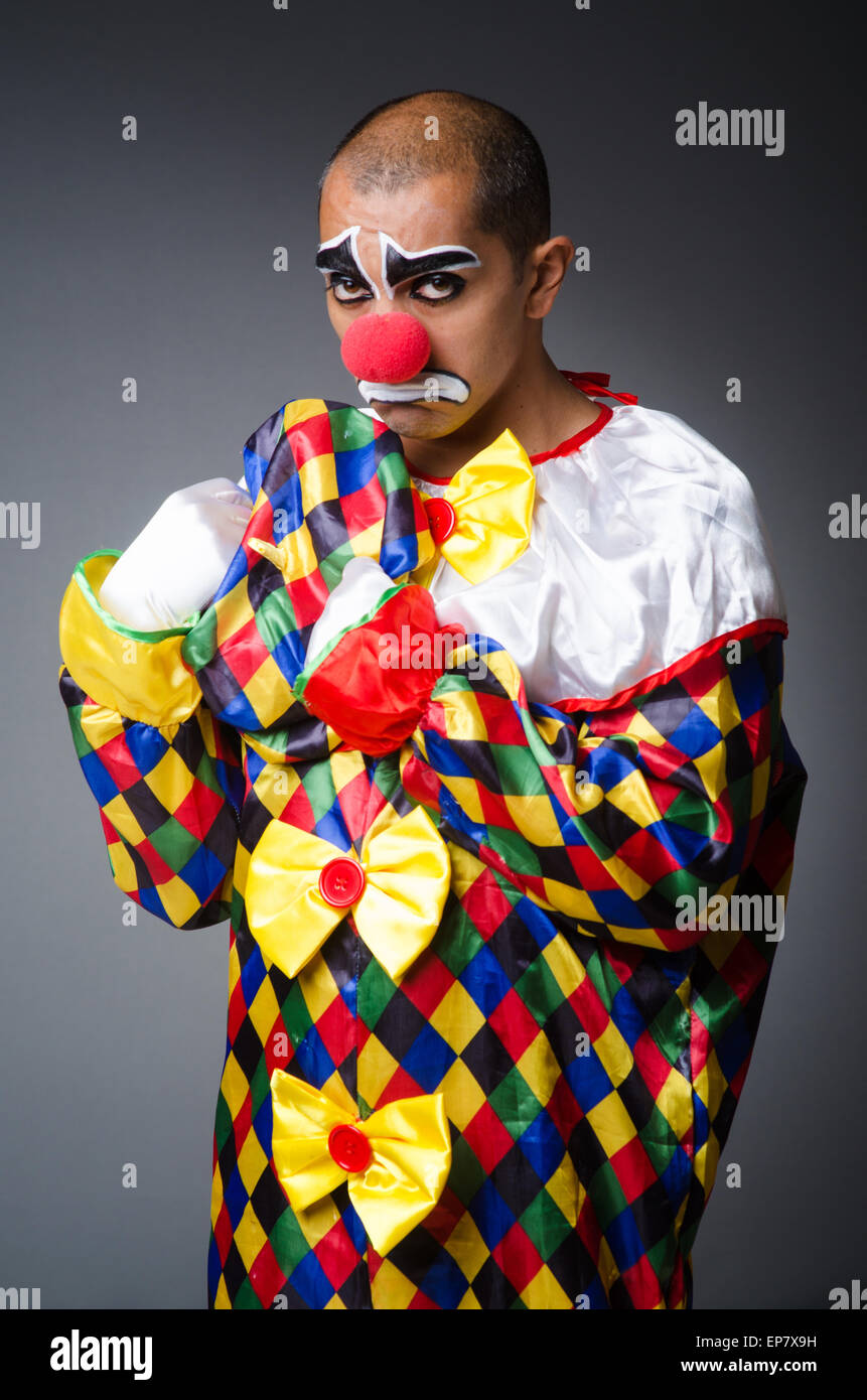 Sad clown against dark background Stock Photo - Alamy